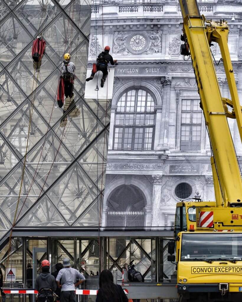 JR transforms the Louvre’s pyramid with an anamorphic image.